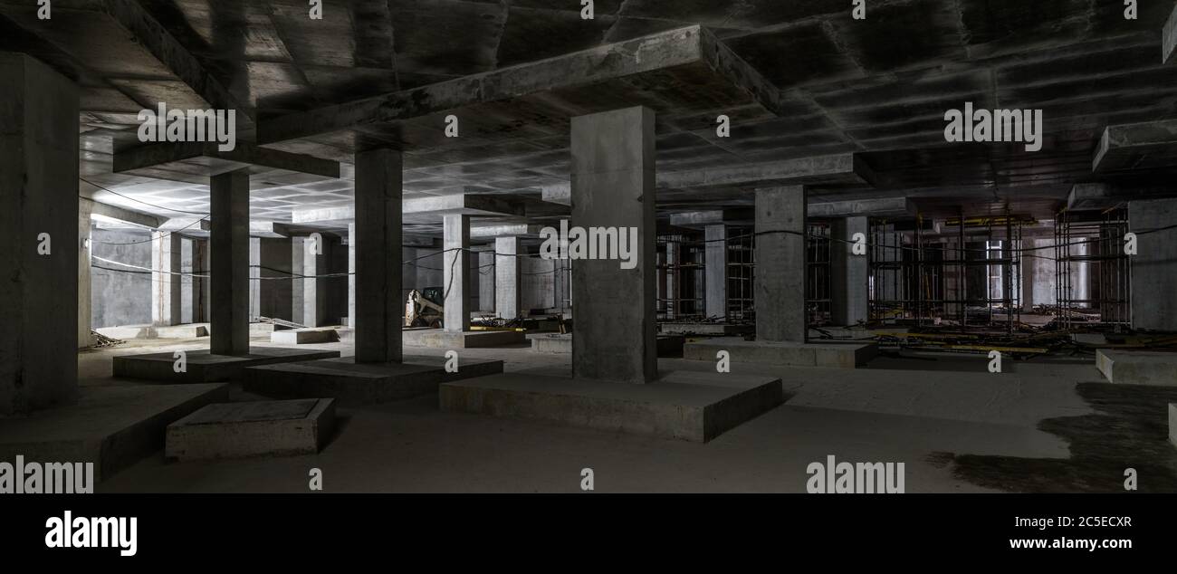 Concrete construction of basement of large building. Panorama inside ...