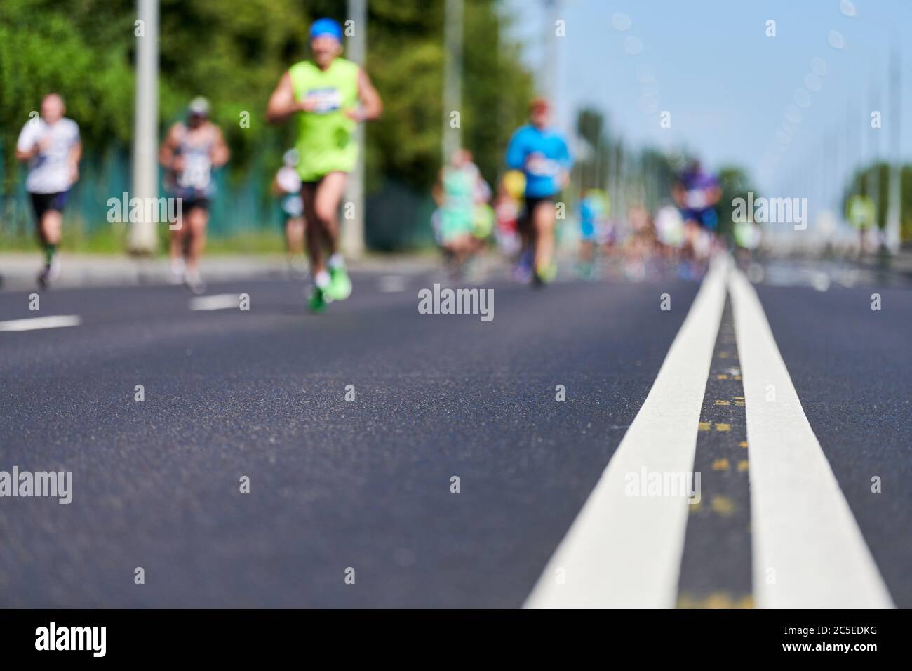 Runners on city road. Running marathon, copy space. Street sprinting ...