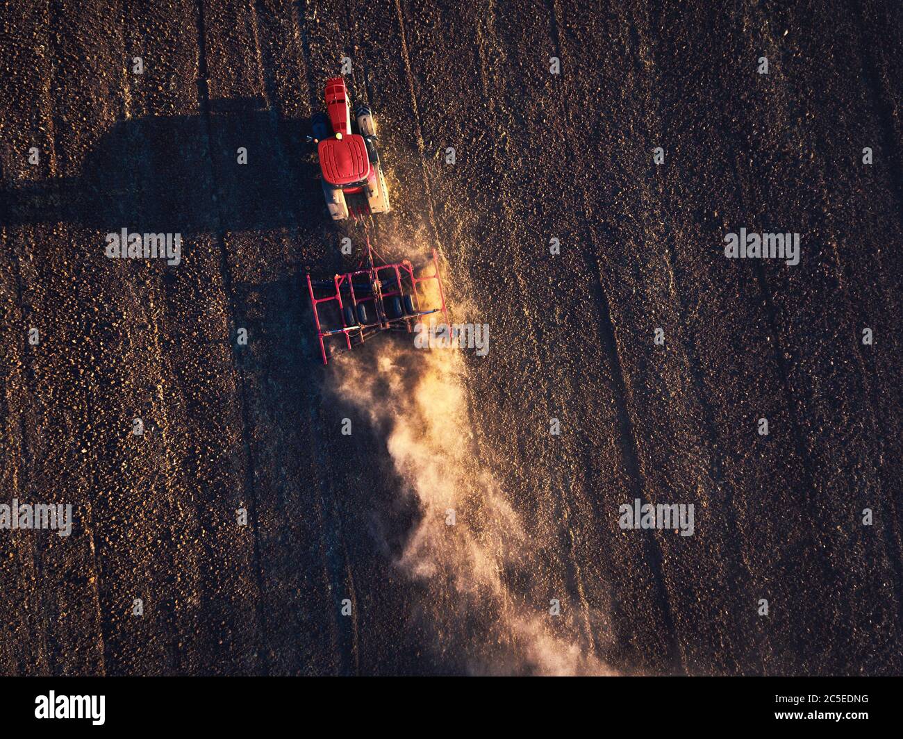 Farmer in tractor preparing land with cultivator, aerial view Stock ...