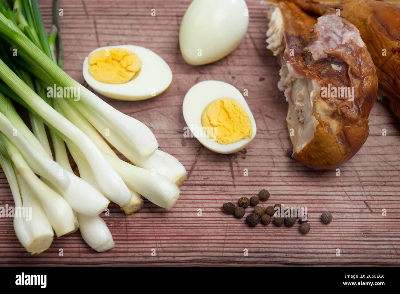 Boiled eggs, fresh chives and smoked chicken laid out on a board Stock ...
