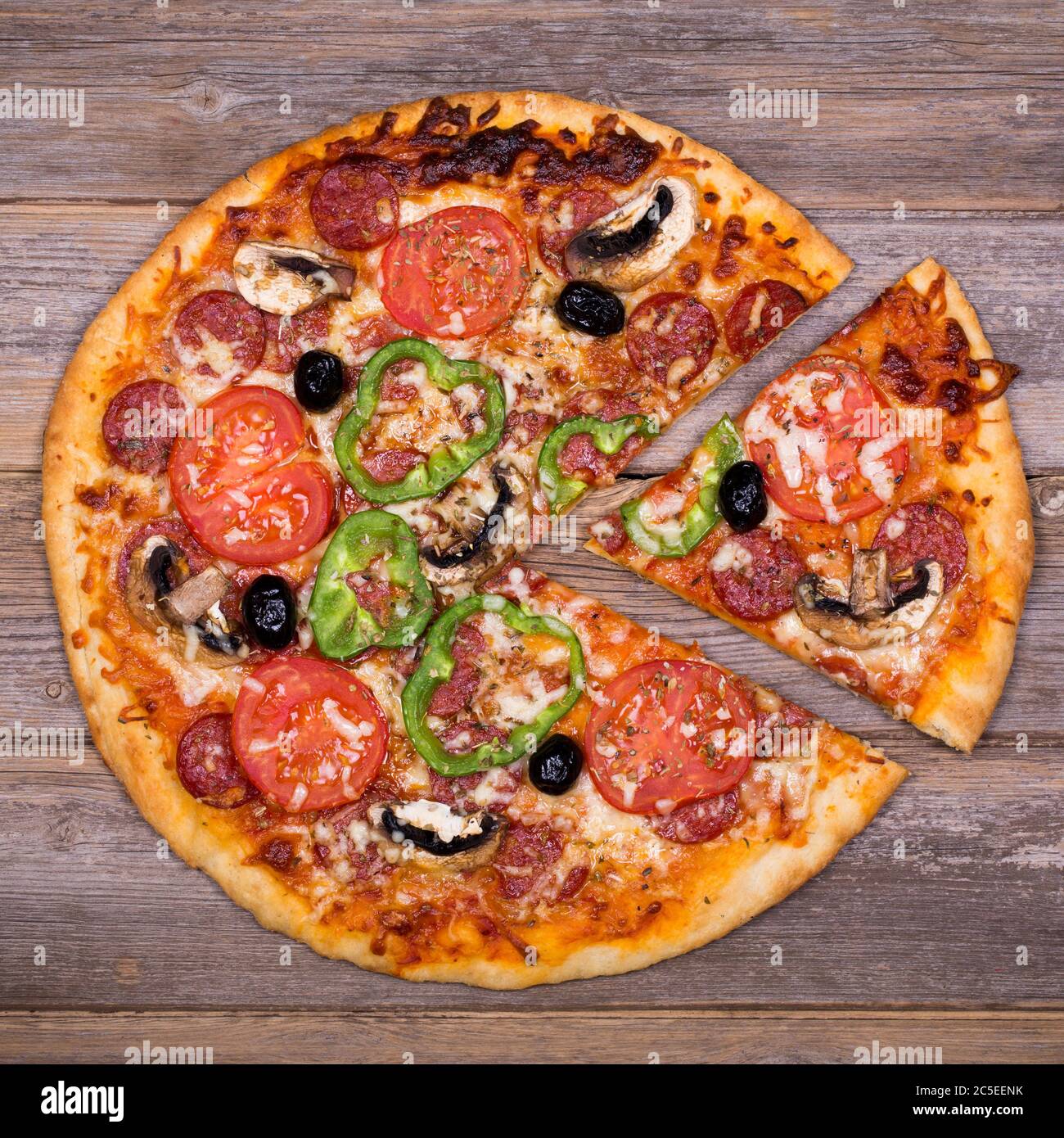 Pepperoni pizza with sliced vegetables on rustic wood background Stock ...