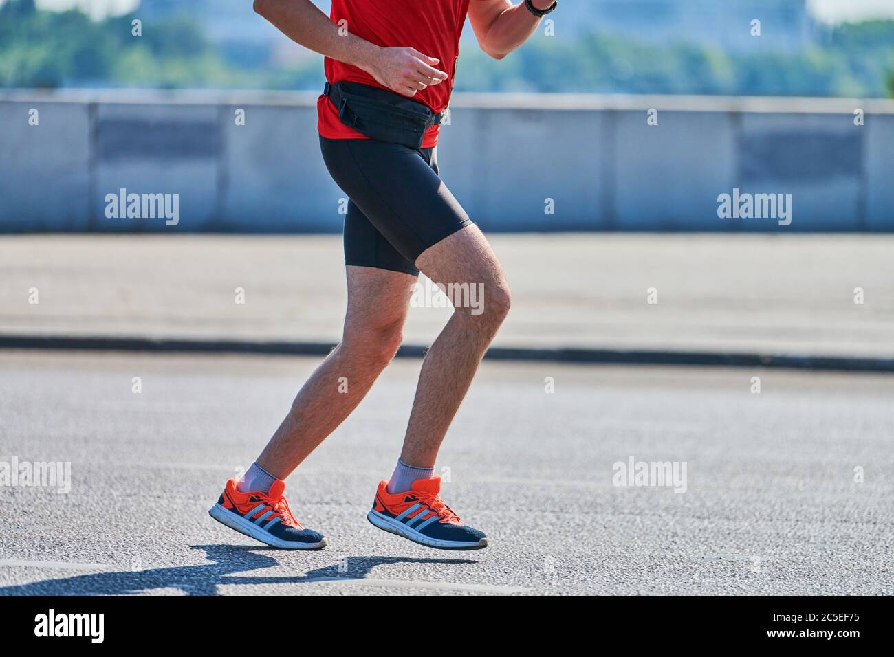 Running man. Athletic man jogging in sportswear on city road. Healthy ...
