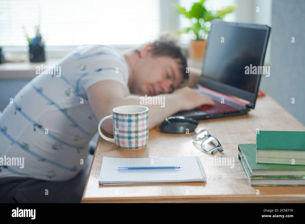 Tired of hard work student guy sleeping on laptop at table Stock Photo ...