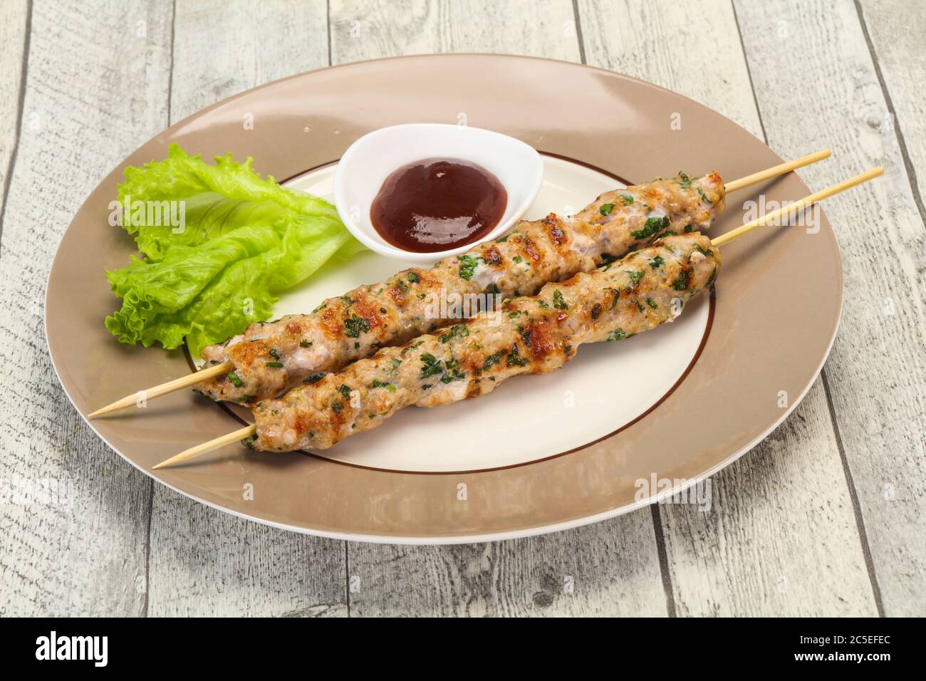 Minced pork skewer kebab with bbq sauce Stock Photo - Alamy