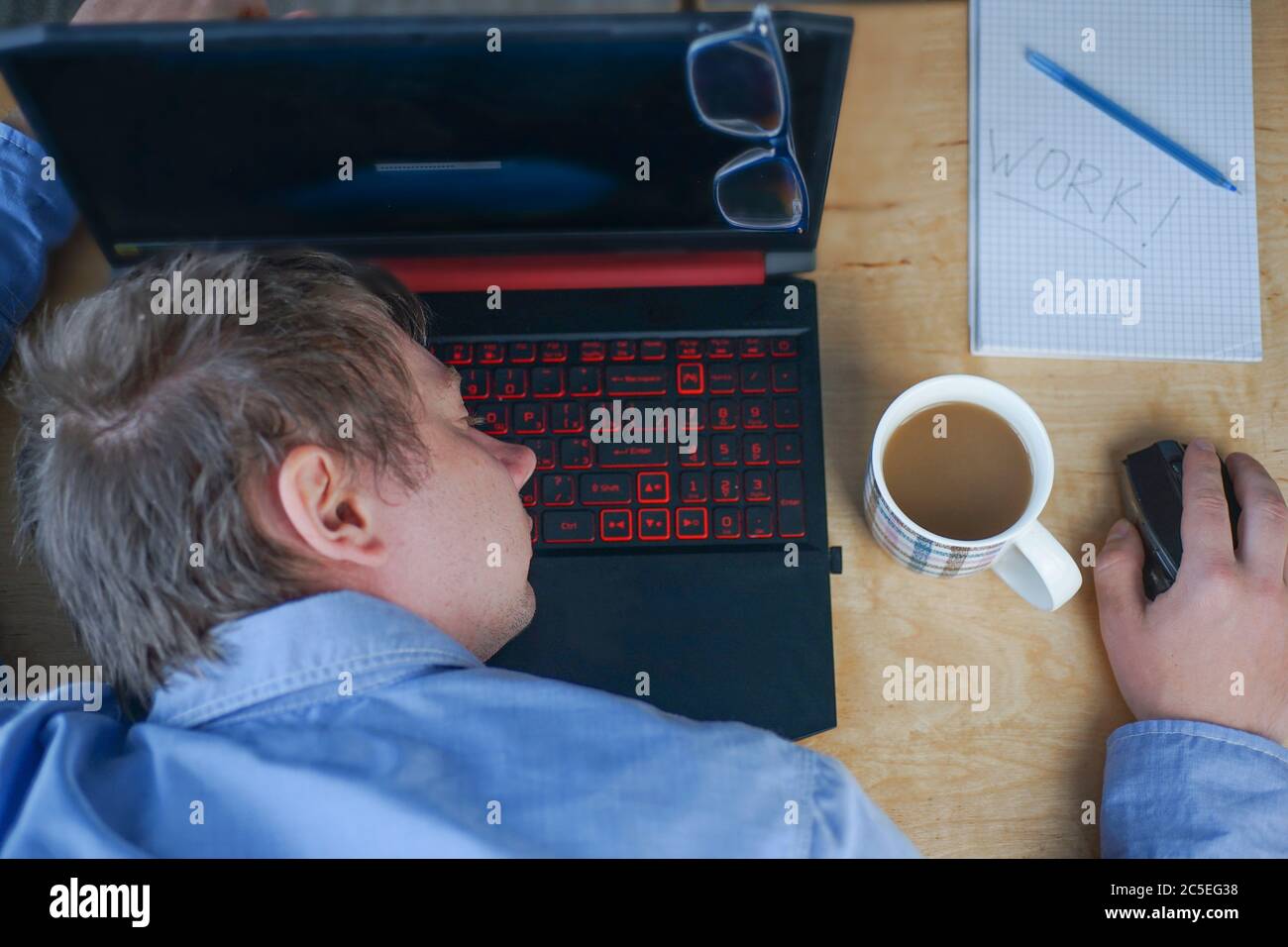 Tired of hard work student guy sleeping on laptop at table Stock Photo ...