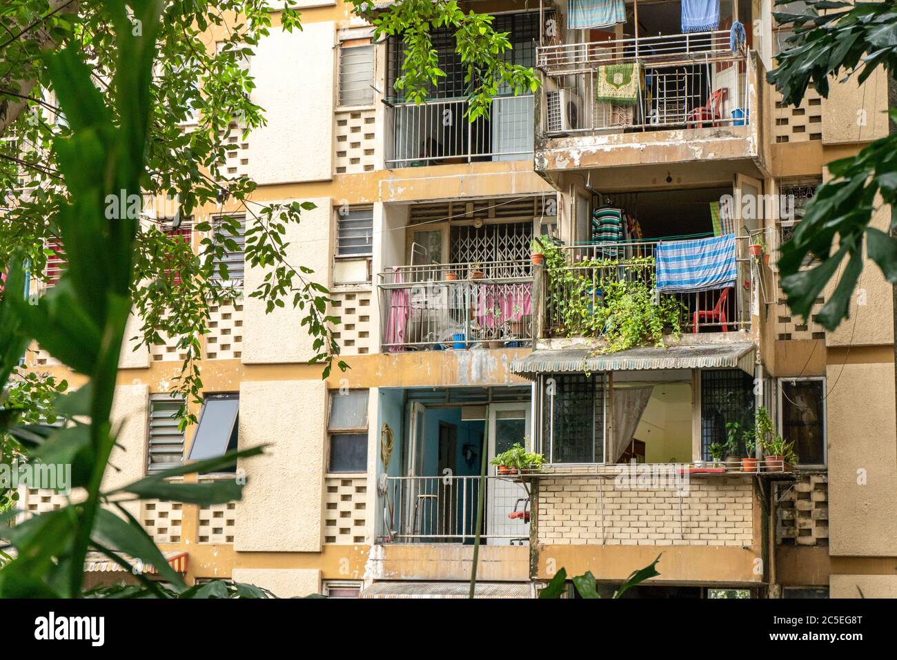 The balconies of an apartment building are hung with clothes. The poor ...