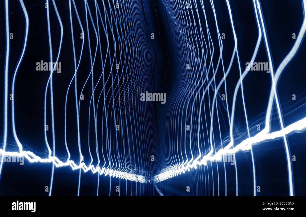 Light trails pattern in metro tunnel, long exposure of movement. Blue ...