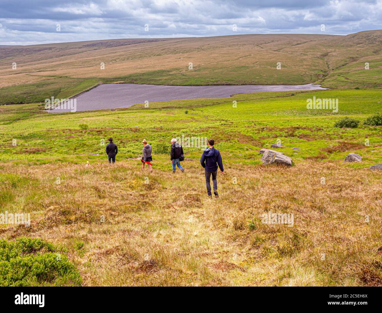 Walkers descending Buckstones Slack towards March Haigh Reservoir Stock ...