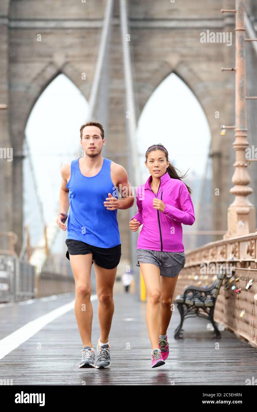 Running couple jogging in New York City Stock Photo - Alamy