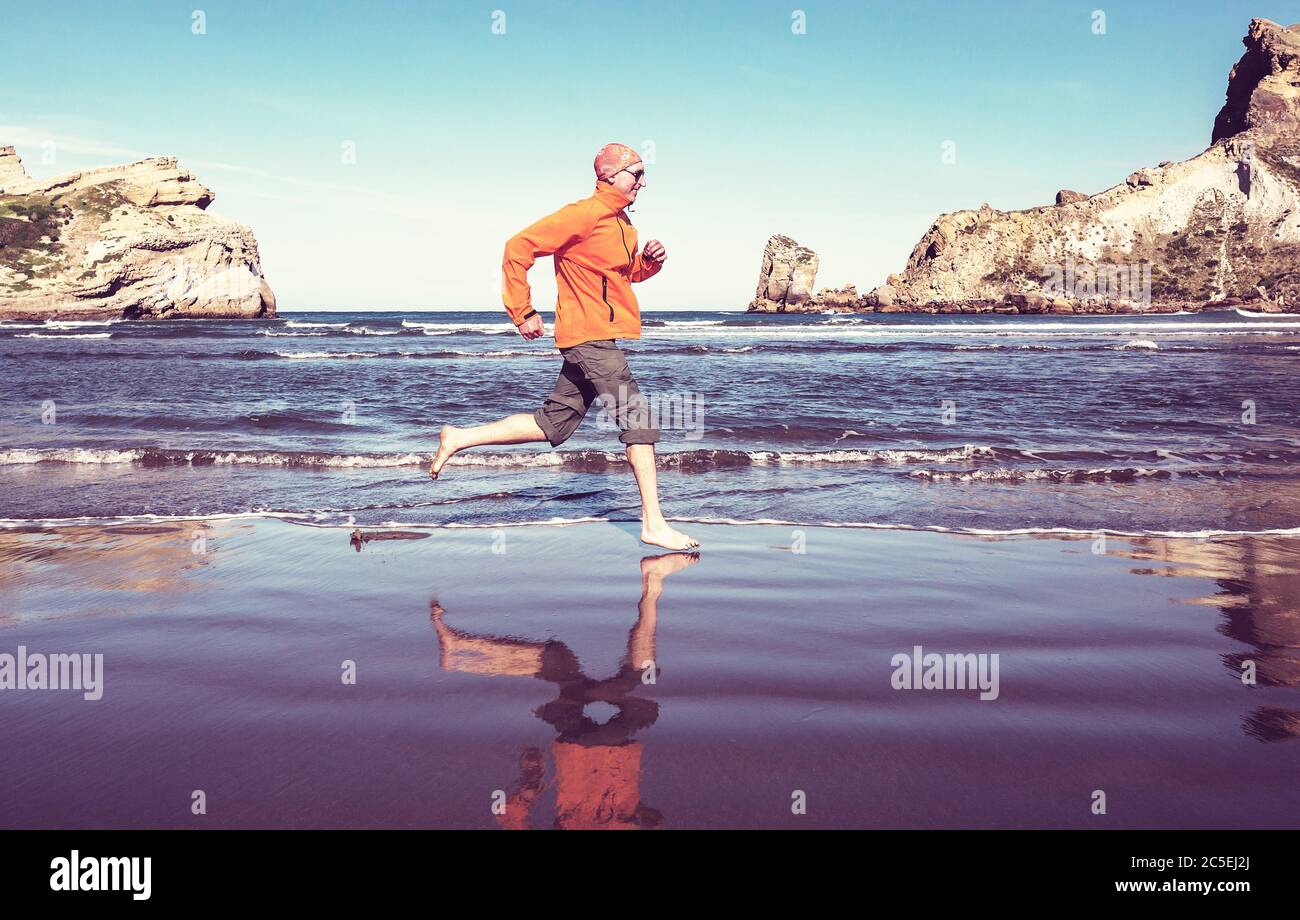 Running man in ocean coast Stock Photo - Alamy