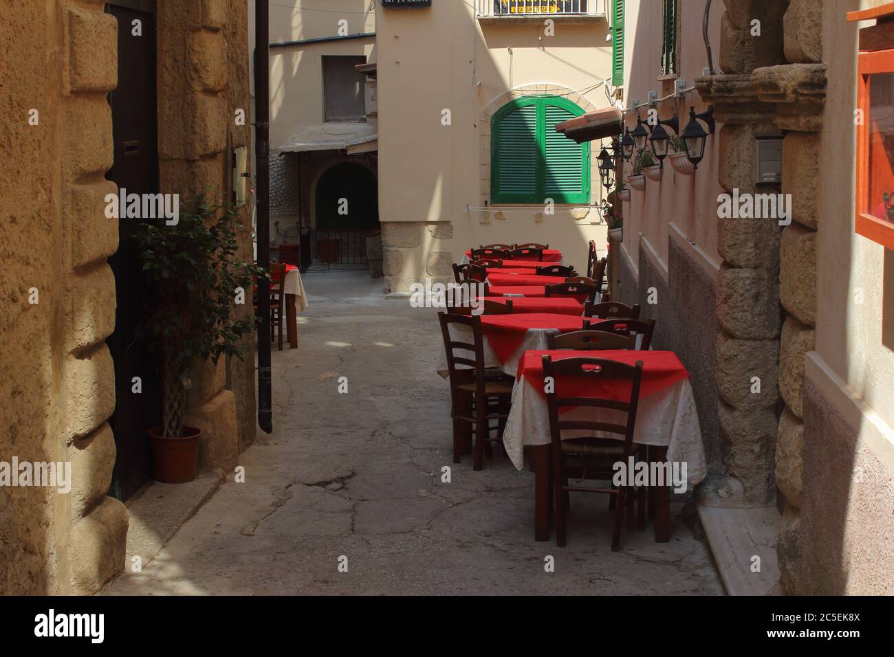 Traditional restaurant exterior with tables and chairs on the street ...