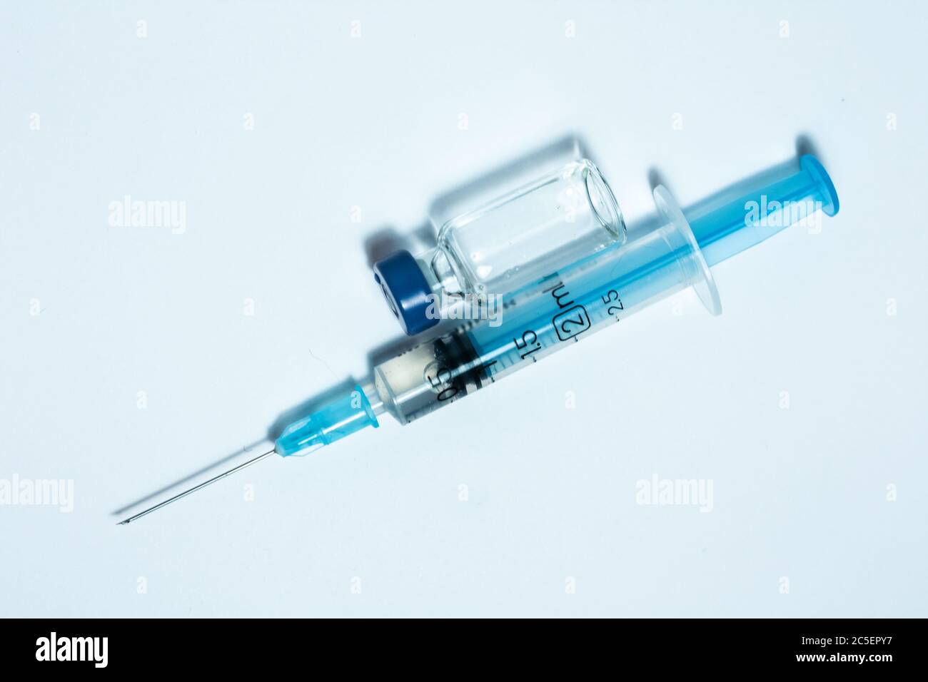 Glass medicine bottle with injection fluid with blue aluminium cap and ...