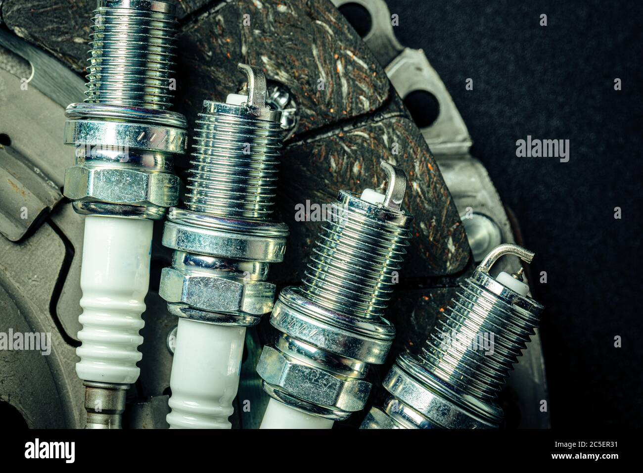 Car spark plugs on black background close up Stock Photo - Alamy