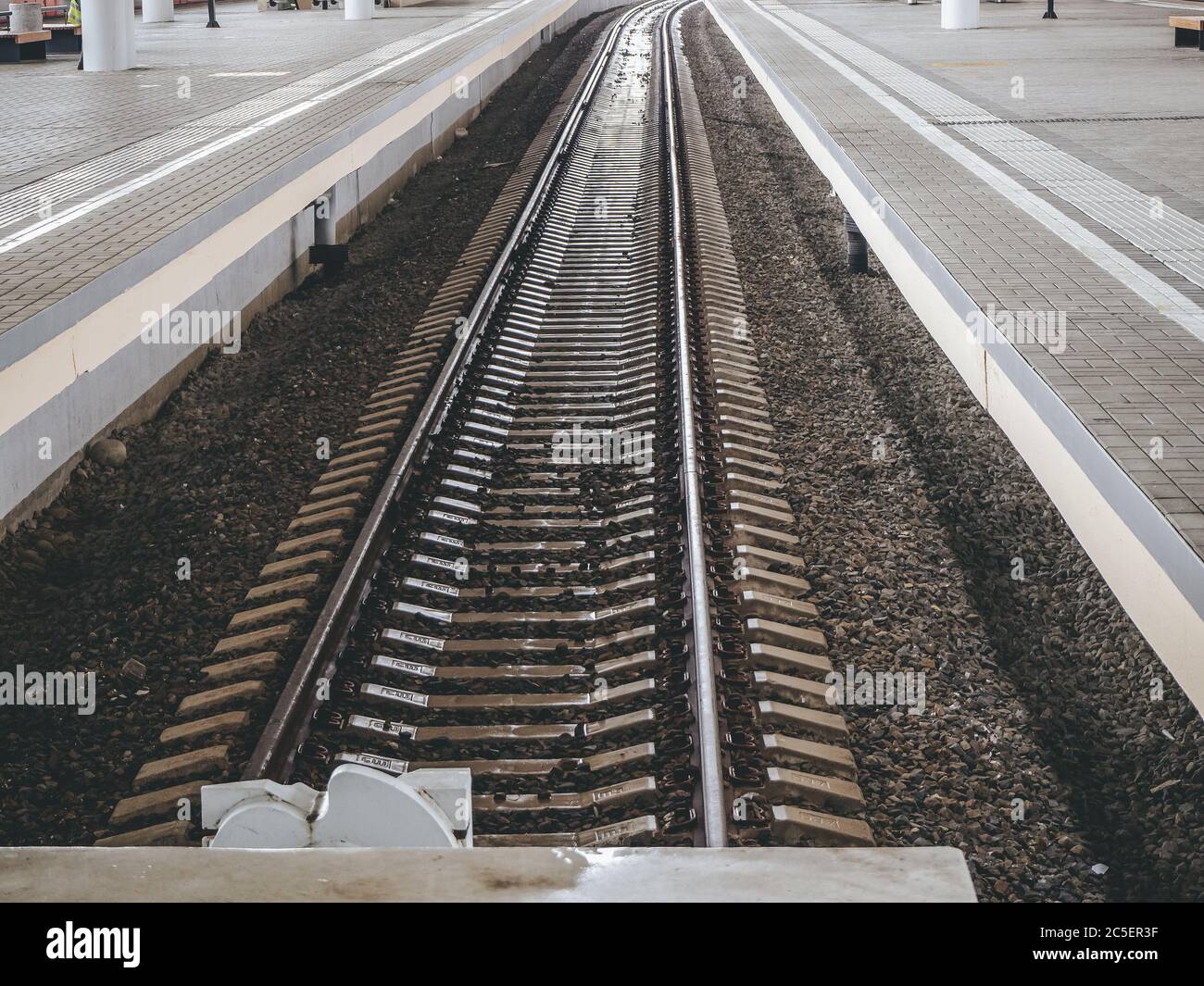 View of the railway rails and sleepers and high side platforms. Long ...