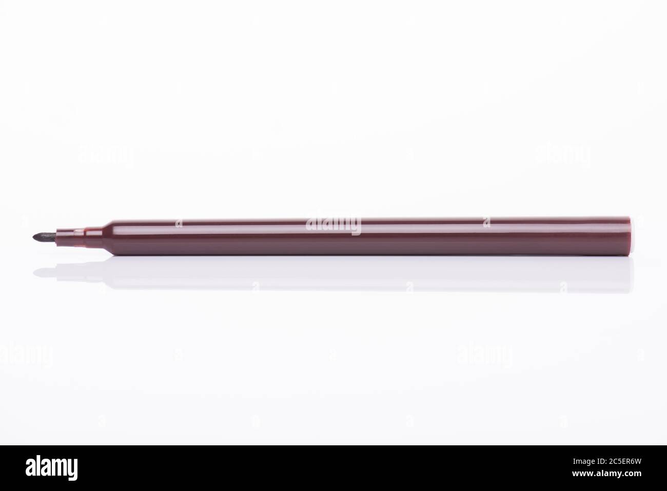 Side profile view close-up photo of brown marker with cap off isolated ...