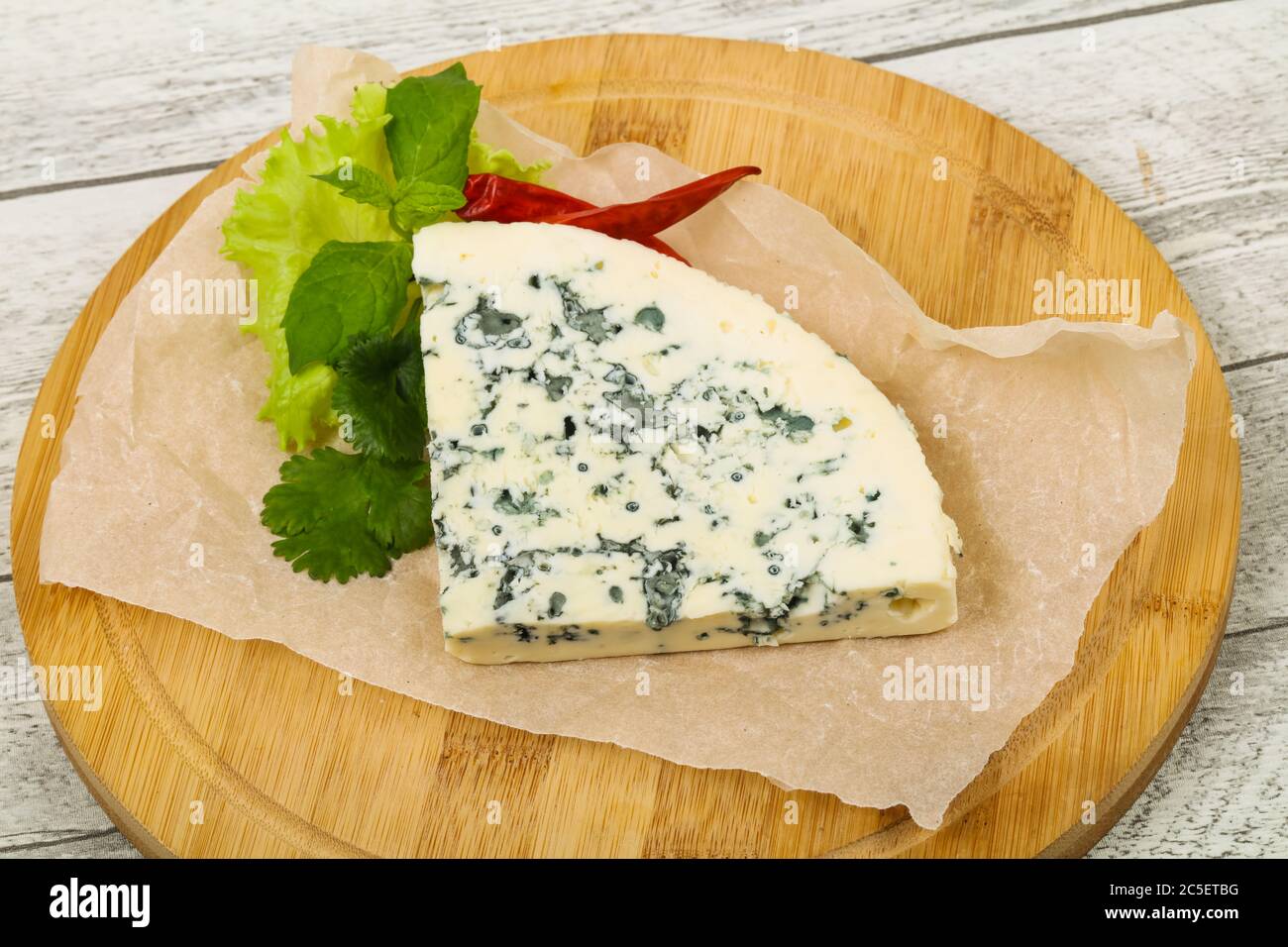 Blue cheese slice with salad leaves Stock Photo - Alamy
