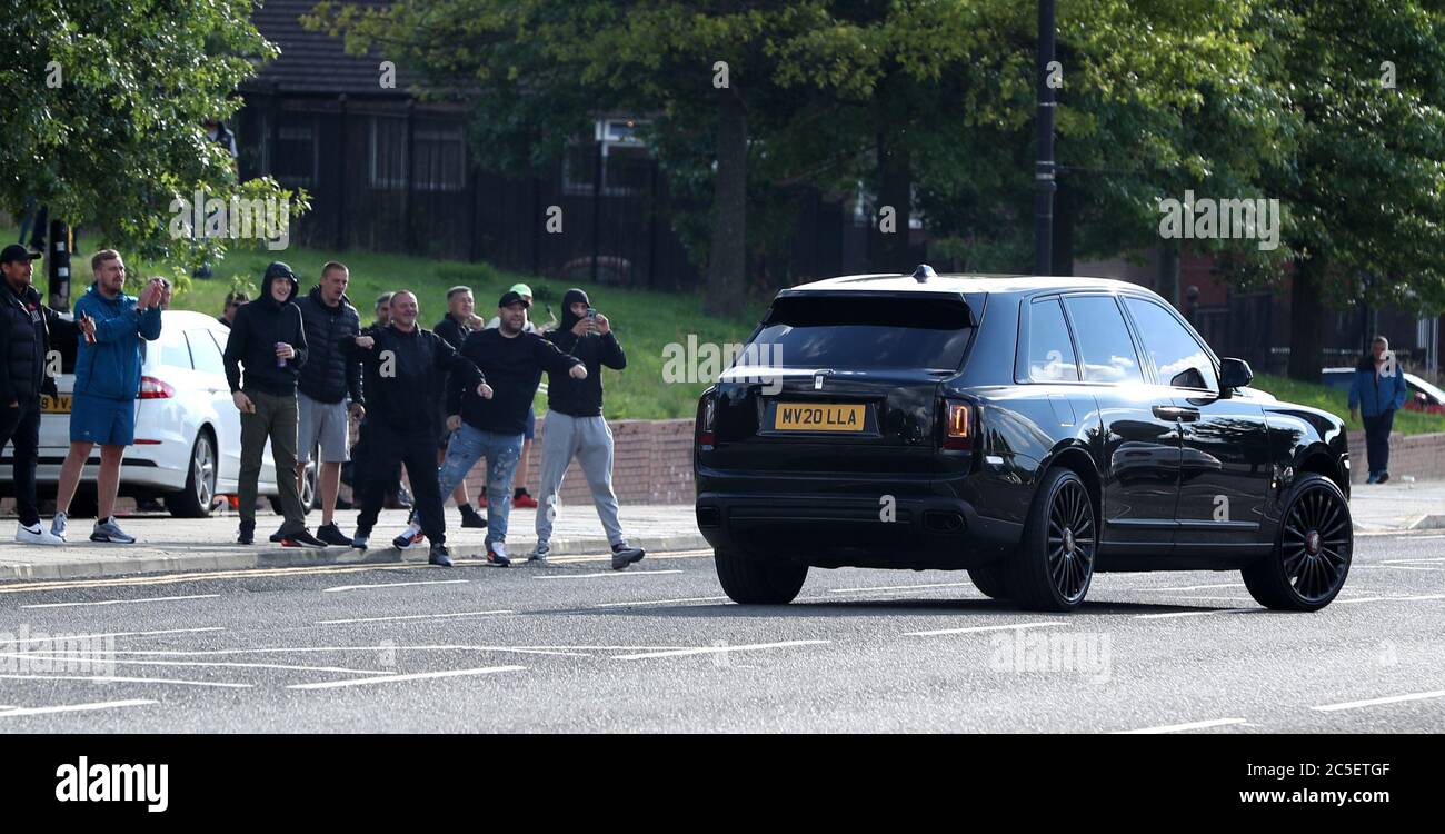 Fans cheer the Manchester City squad members as the arrive at the ...