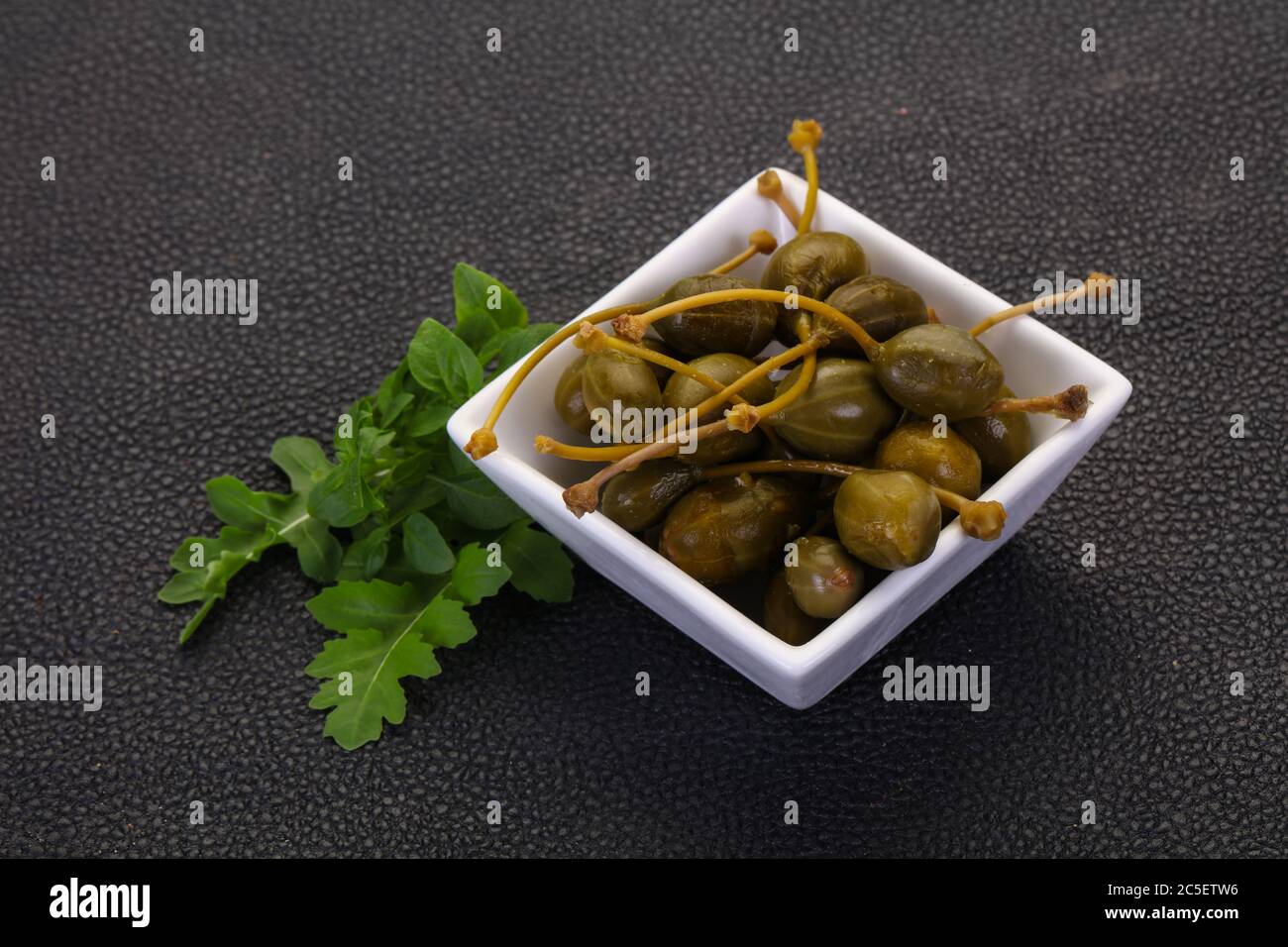Pickled Capersberries in the bowl with basil Stock Photo - Alamy