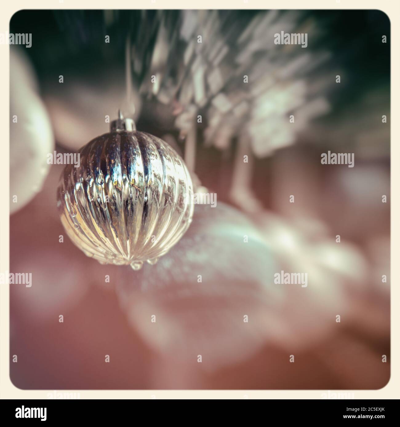 Detail of christmas baubles with tinsel. Selective focus and bokeh background. Cross-processed ...