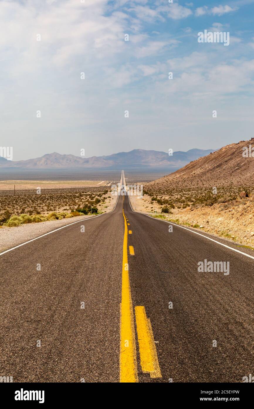 Looking down the long straight road leading to Death Valley Stock Photo ...