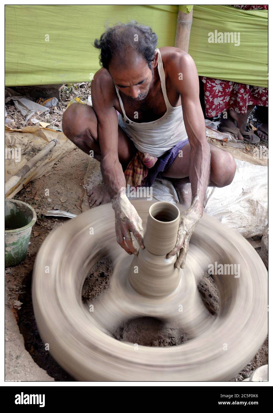 A potter making a flower vase at Bashkhali, Chittagong, Bangladesh ...