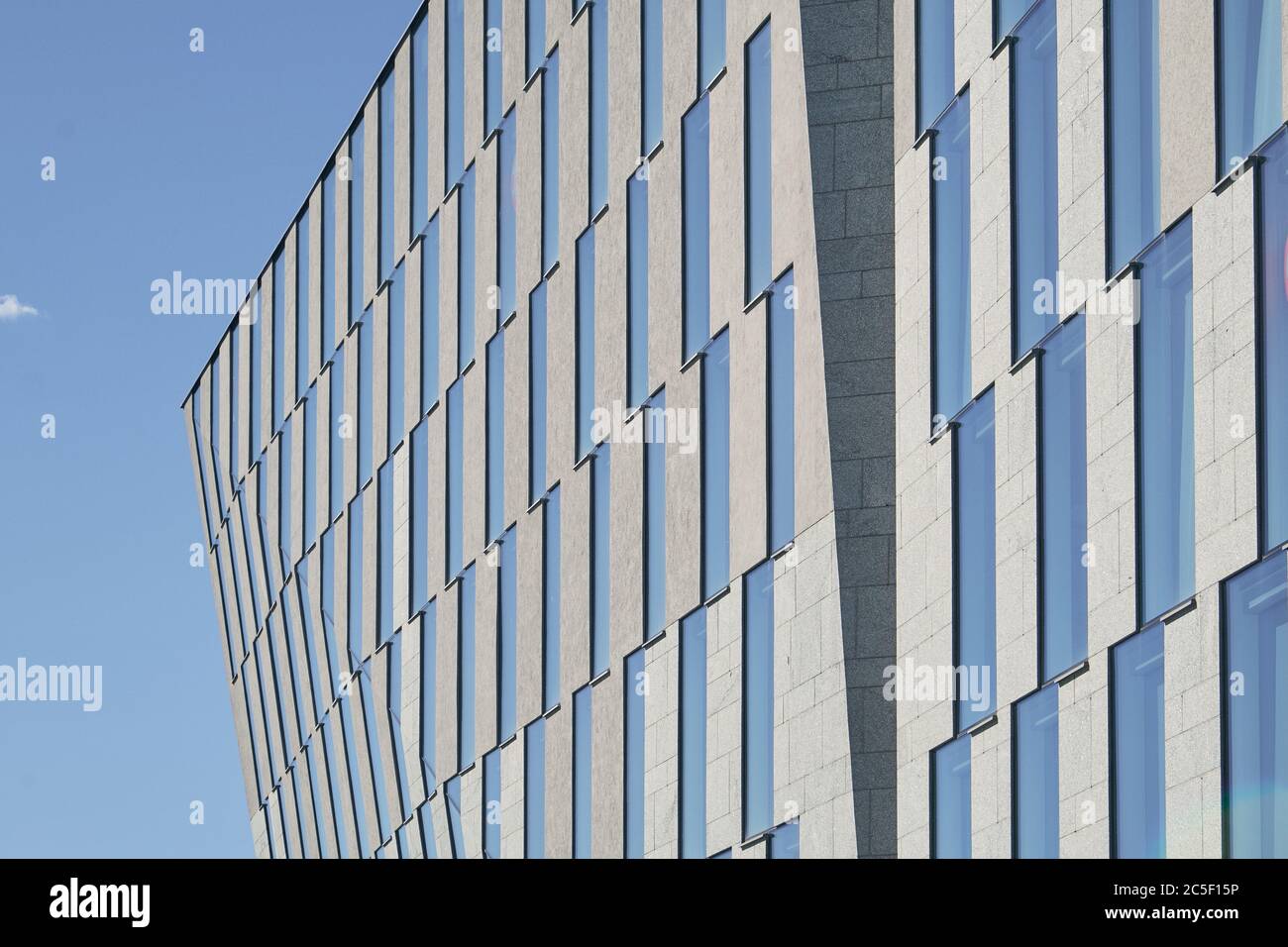 The facade of the modern building from glass, metal, and stone in ...
