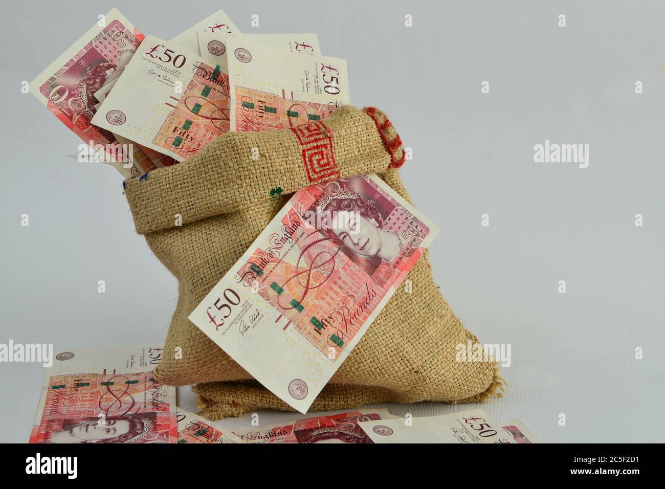 British money Fifty pound note in a Sack , on white background ...