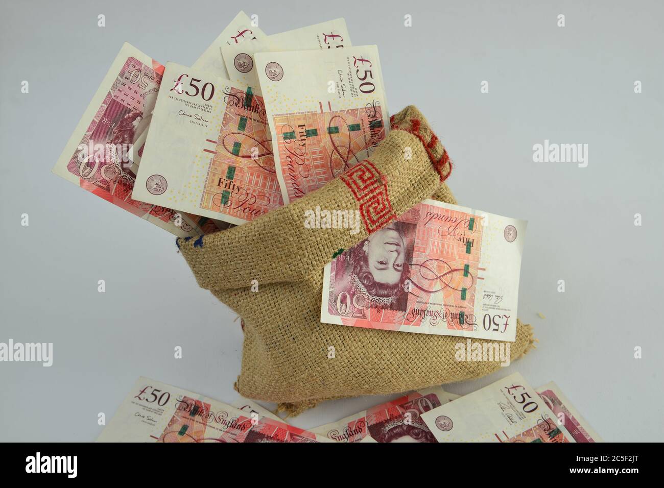 British money Fifty pound note in a Sack , on white background ...