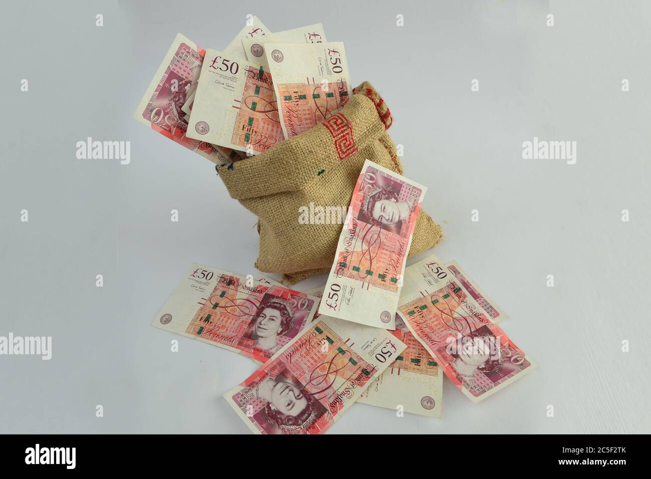 British money Fifty pound note in a Sack , on white background ...