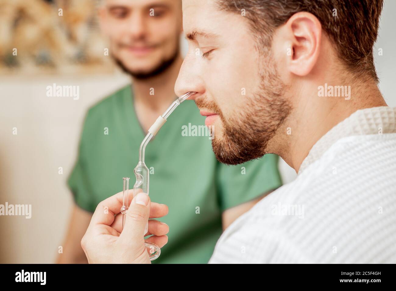 Man receives nasal inhalation Maholda by essential oil in nose at spa ...