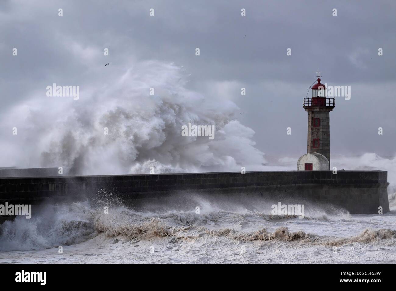 Big stormy sea wave splash over piers and old lighthouse, Portugal ...