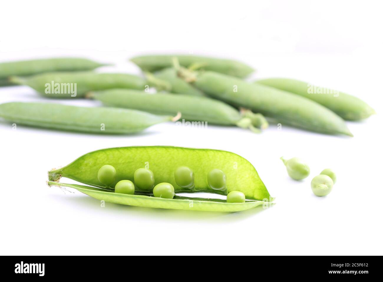 Fresh peas on white background Stock Photo - Alamy