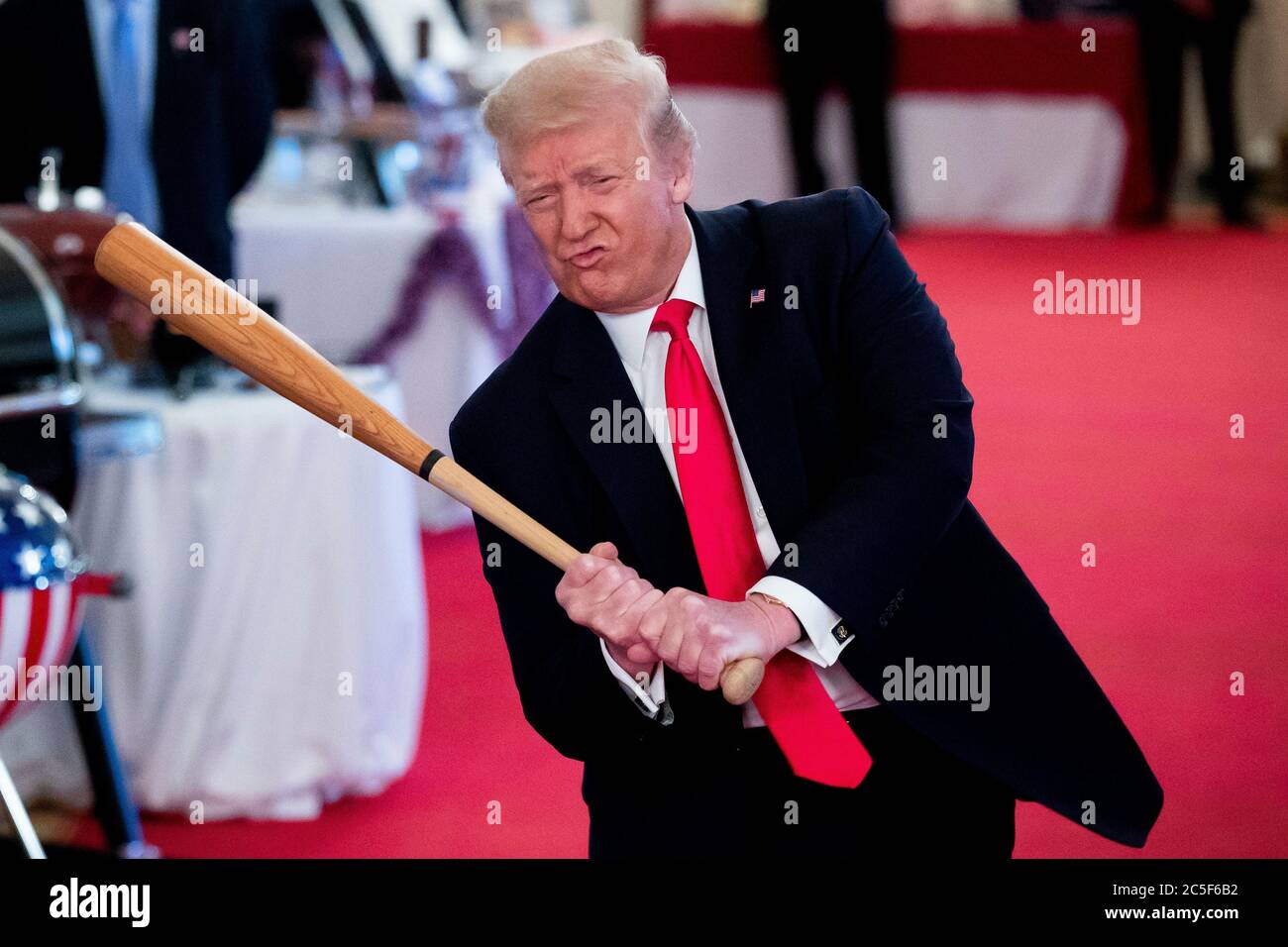 US President Donald J. Trump swings a baseball bat made by Texas Timber ...