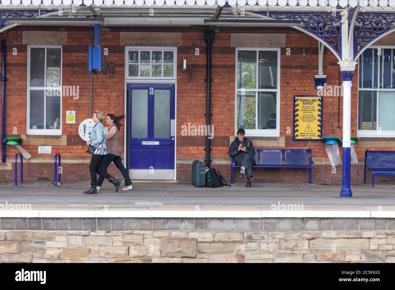 Passengers at Stalybridge railway station rushing along the platform ...