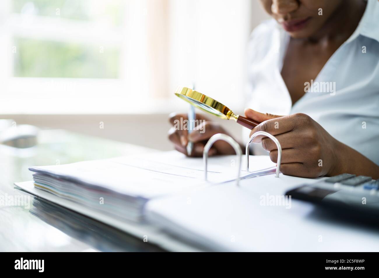 Auditor Investigating Business Fraud Using Magnifying Glass In Office ...