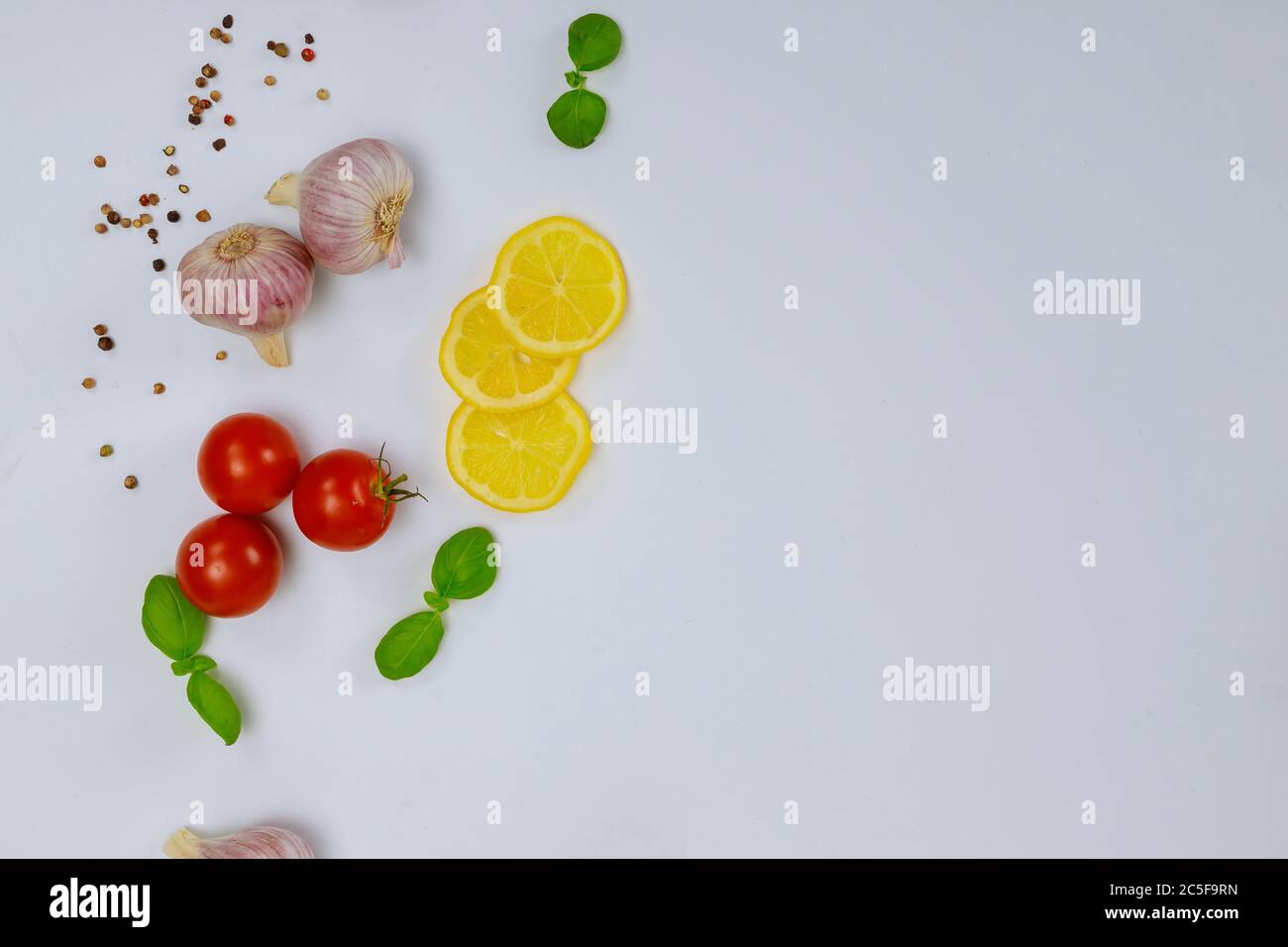 Natural spices with lemon and tomato on white background Stock Photo ...
