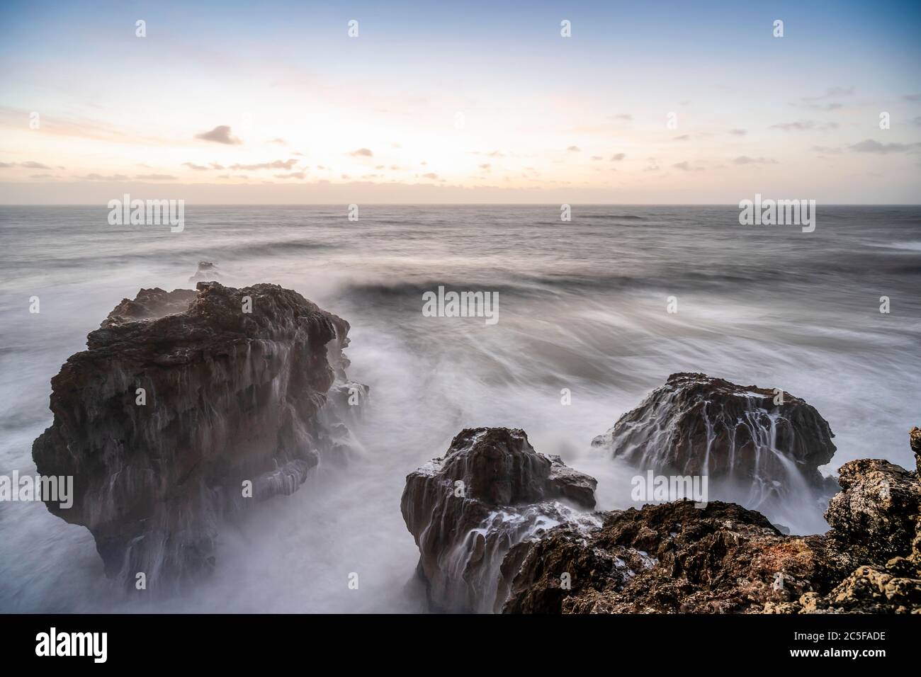 Washed over rocks, Atlantic Ocean, evening light, Nazare, Portugal ...