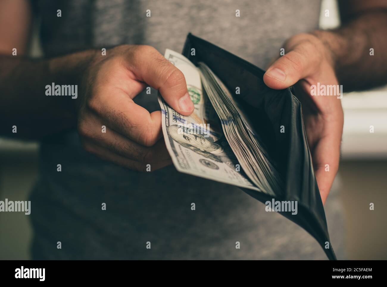 Counting money in black leather hi-res stock photography and images - Alamy