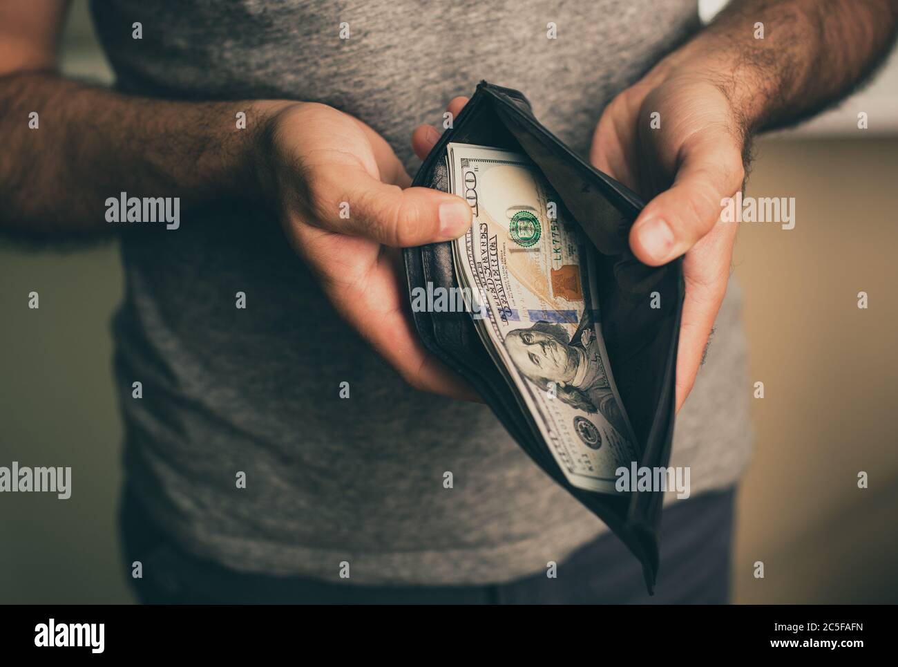 Man looks in the wallet. Cash. Wealthy man counting his money. Close up ...