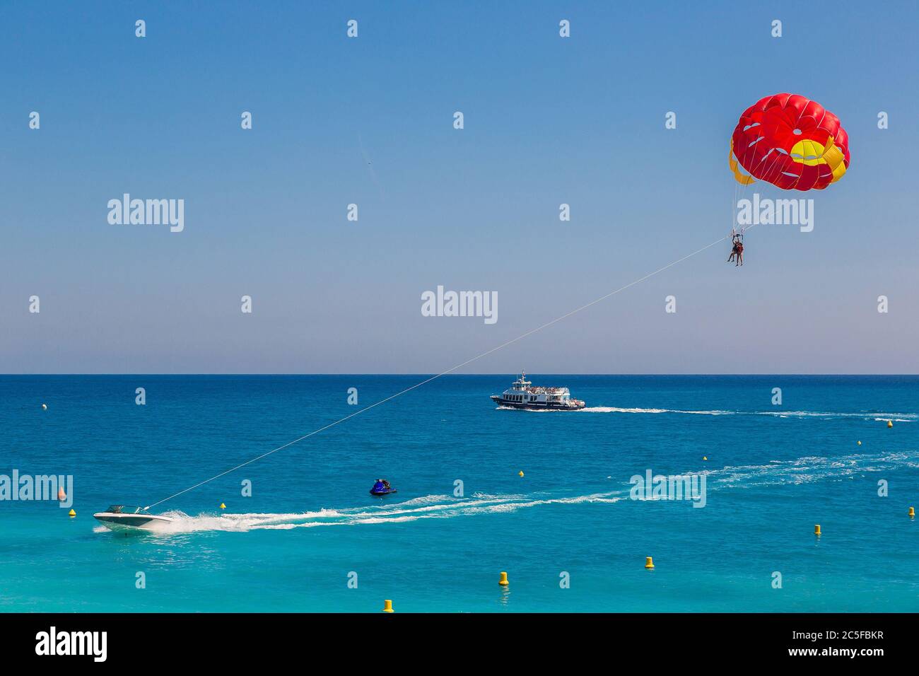 Parachuting in Nice. Parasailing with a boat over sea in Nice in a ...