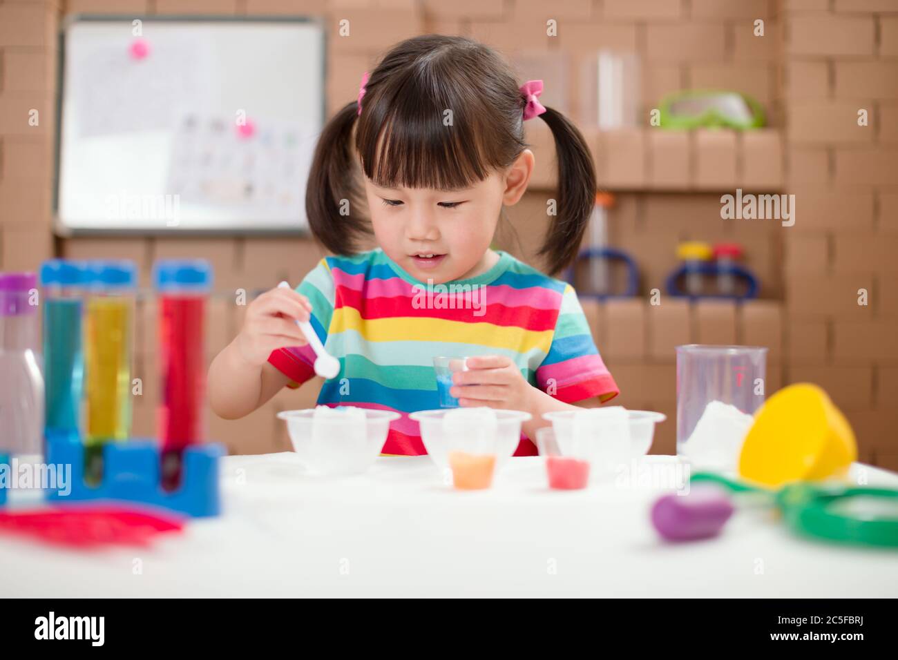 toddler girl play science experiments for homeschooling Stock Photo - Alamy