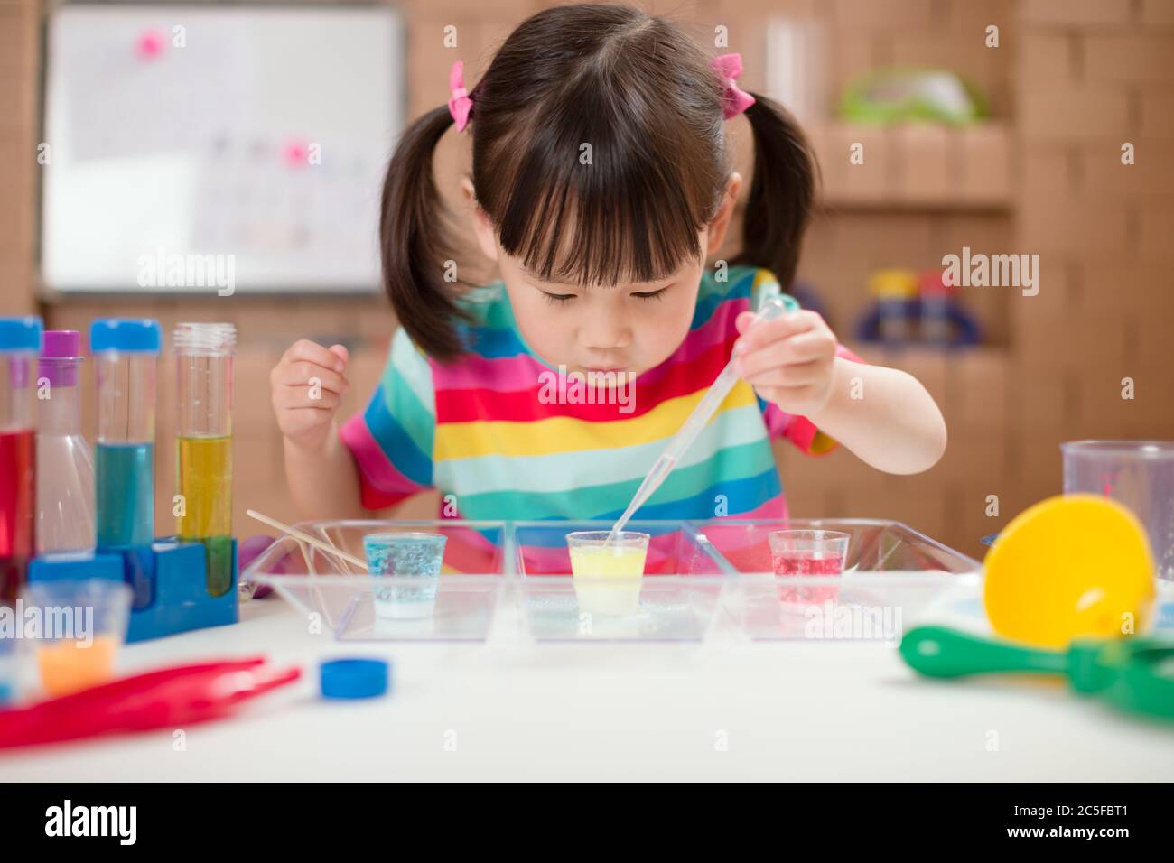 toddler girl play science experiments for homeschooling Stock Photo - Alamy