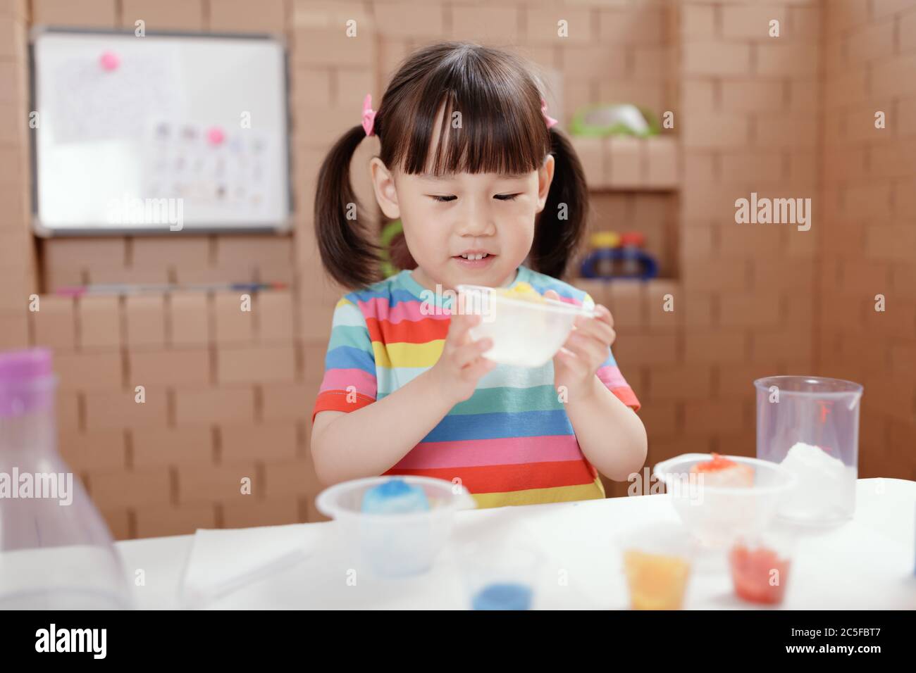 toddler girl play science experiments for homeschooling Stock Photo - Alamy