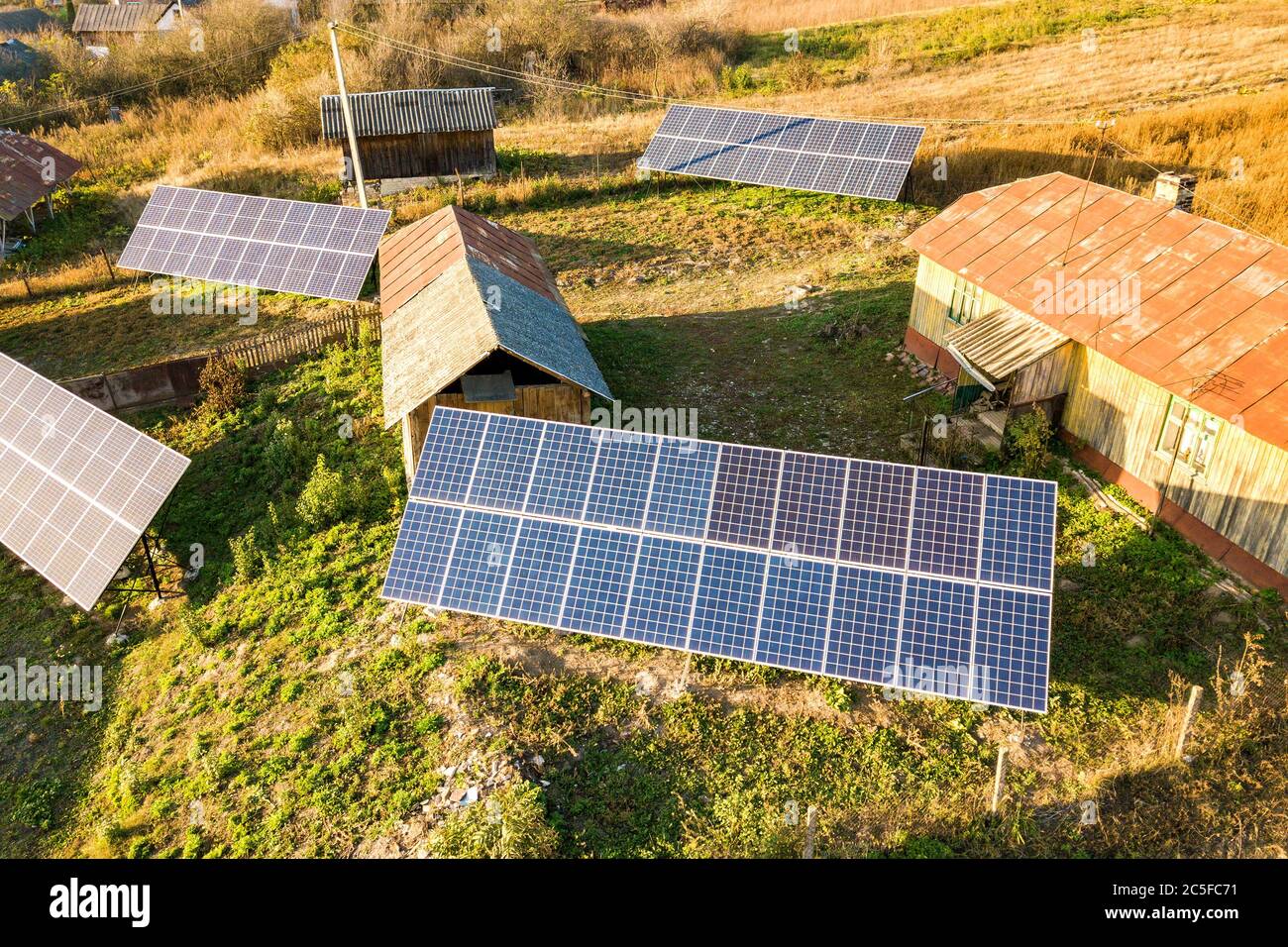 Aerial top down view of solar photo voltaic panels in green rural area ...