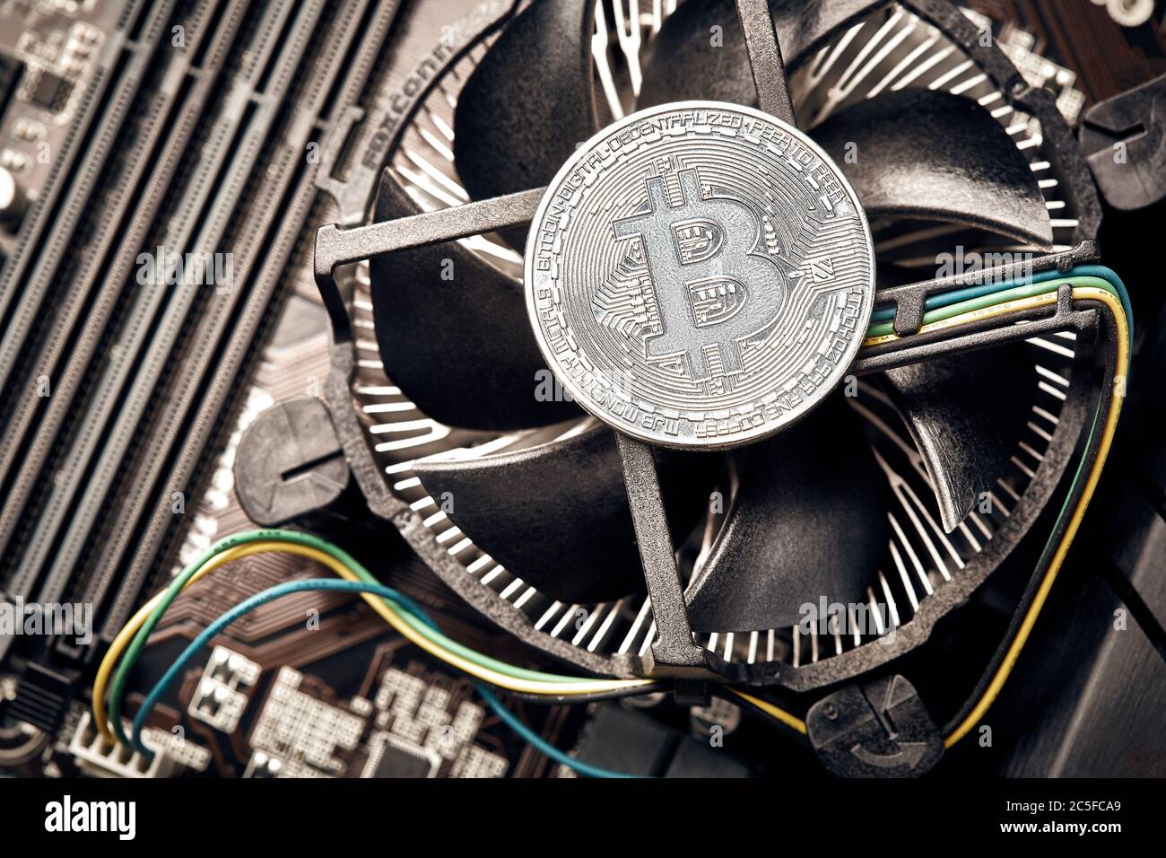 Bitcoin. New virtual money. Bitcoins lie on the video card, concept of ...