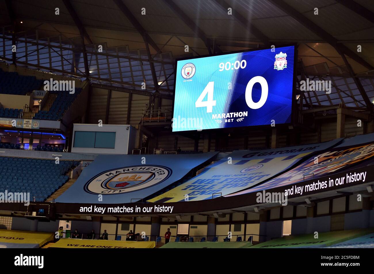 The big screen displays the 4-0 scoreline in the 90th minute during the ...
