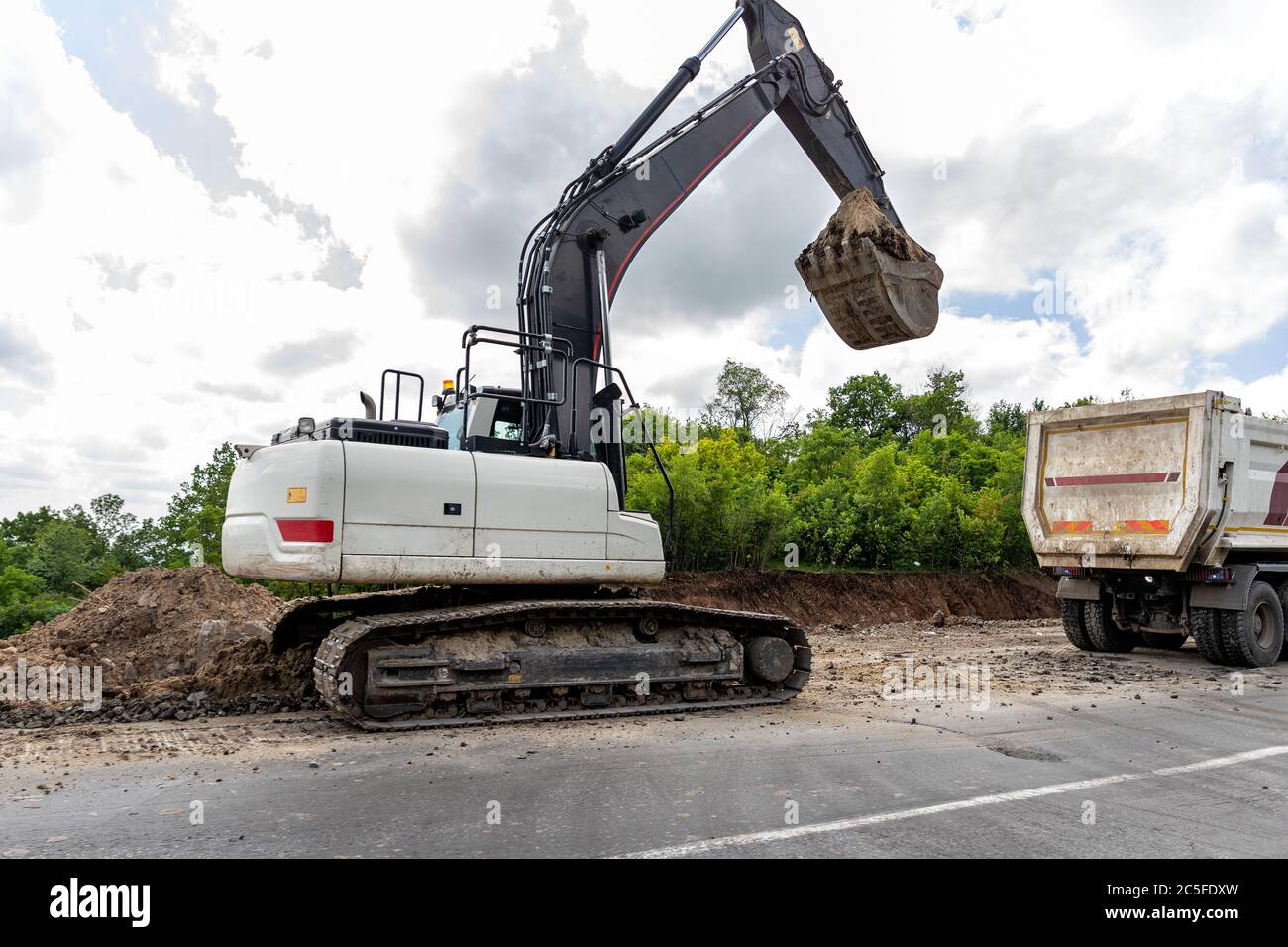 Many heavy heavy industrial road construction machinery on new highway ...