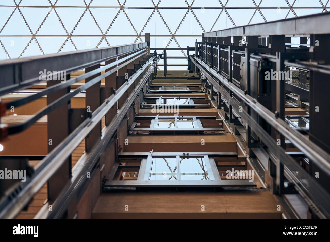 Open elevator lift shaft. Modern architecture with transparent ceiling ...