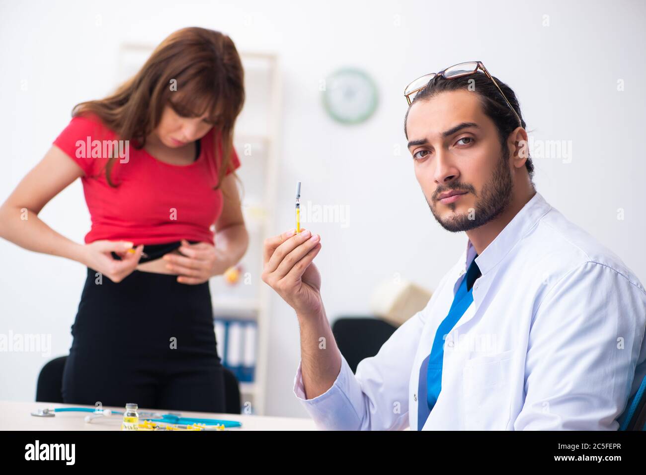 Female diabetic patient visiting young doctor Stock Photo - Alamy