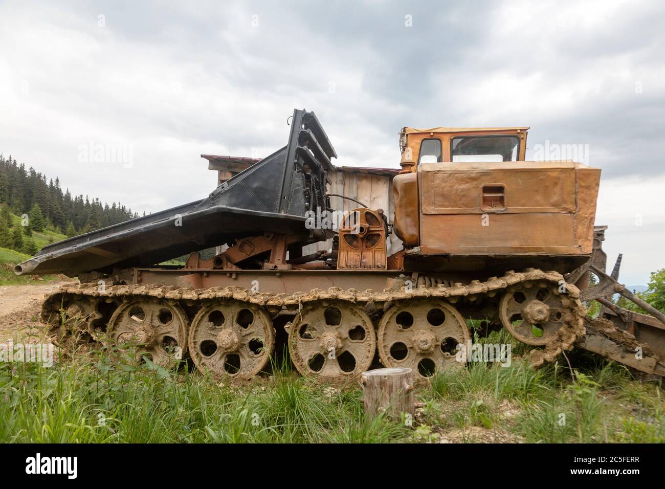 Big old bulldozer in the woods. Vintage tractor with caterpillars ...